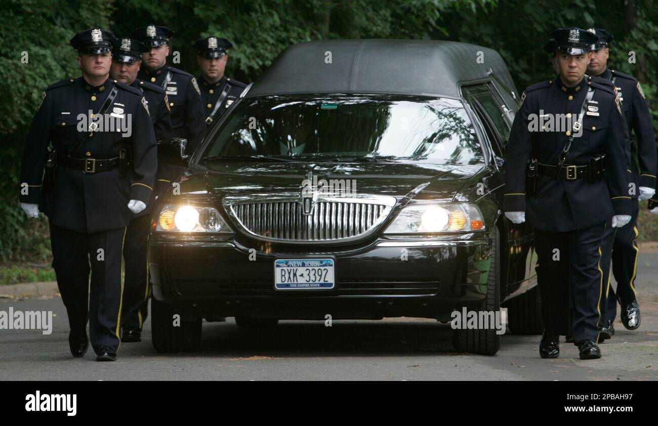 Police officers escort the hearse carrying slain New York police ...