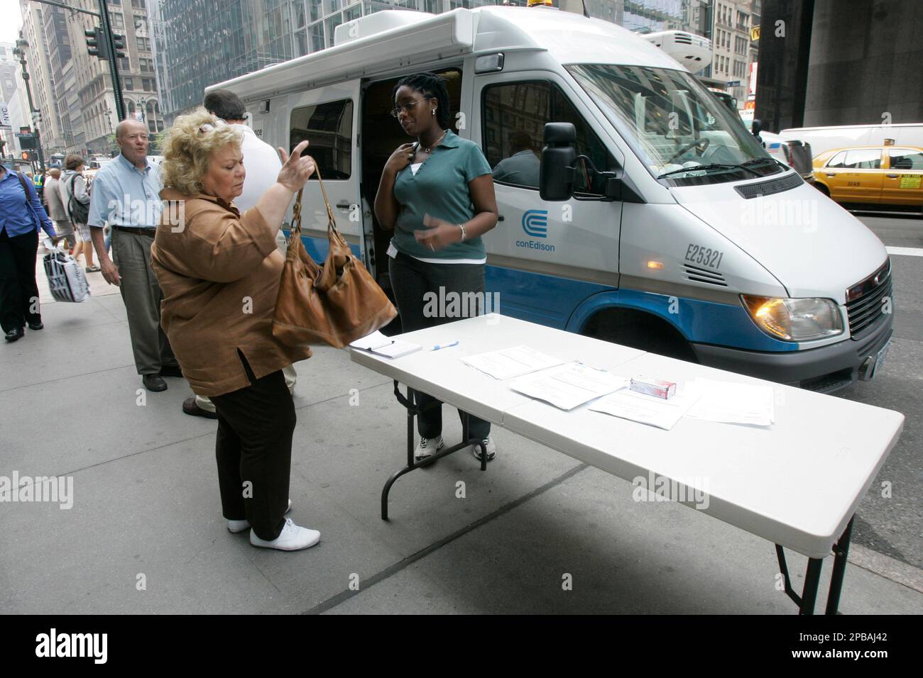 Libby Cohen, left, turns in her purse which was covered in debris from ...