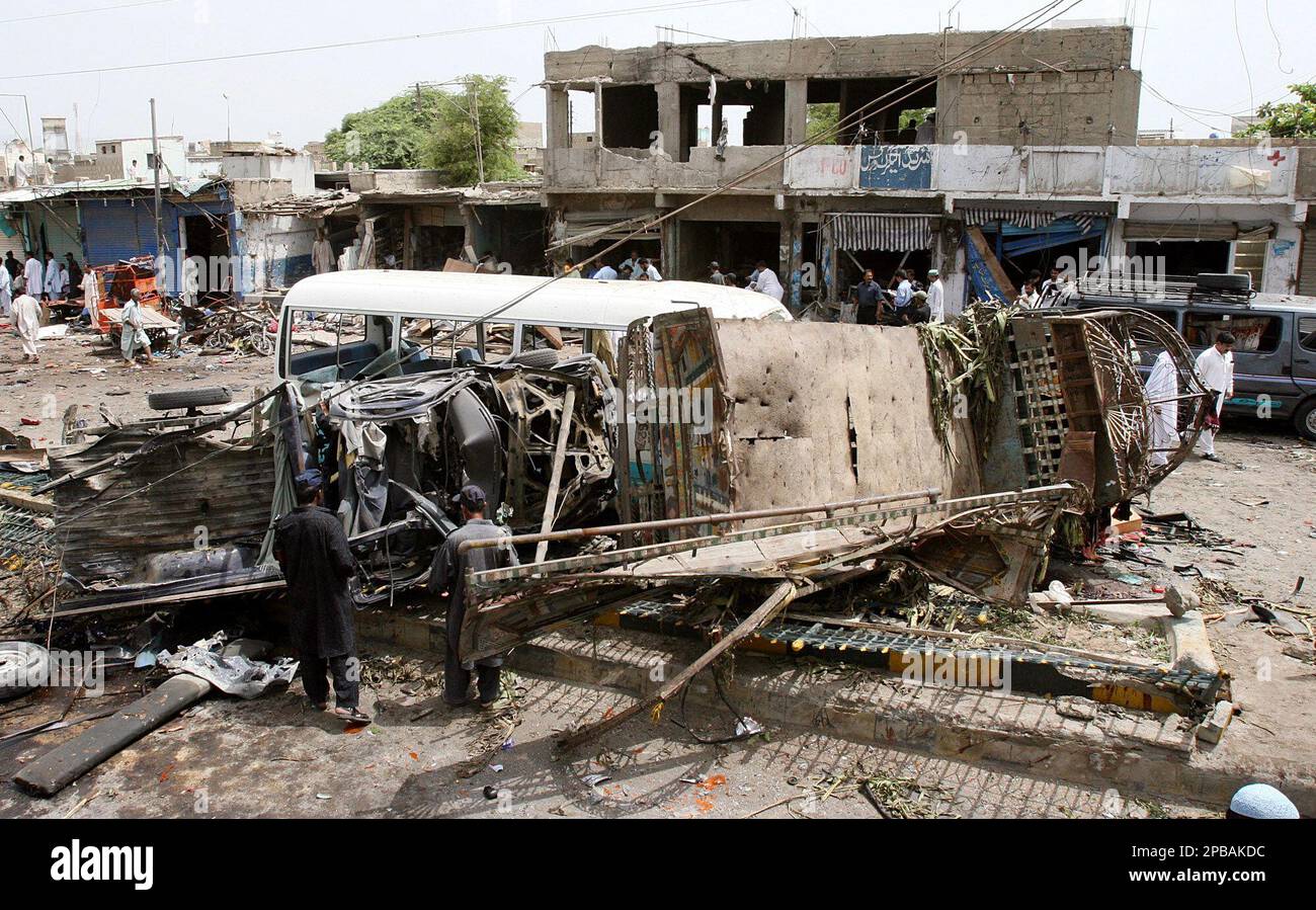 Officials survey the damage caused by a bomb explosion in Hub near ...