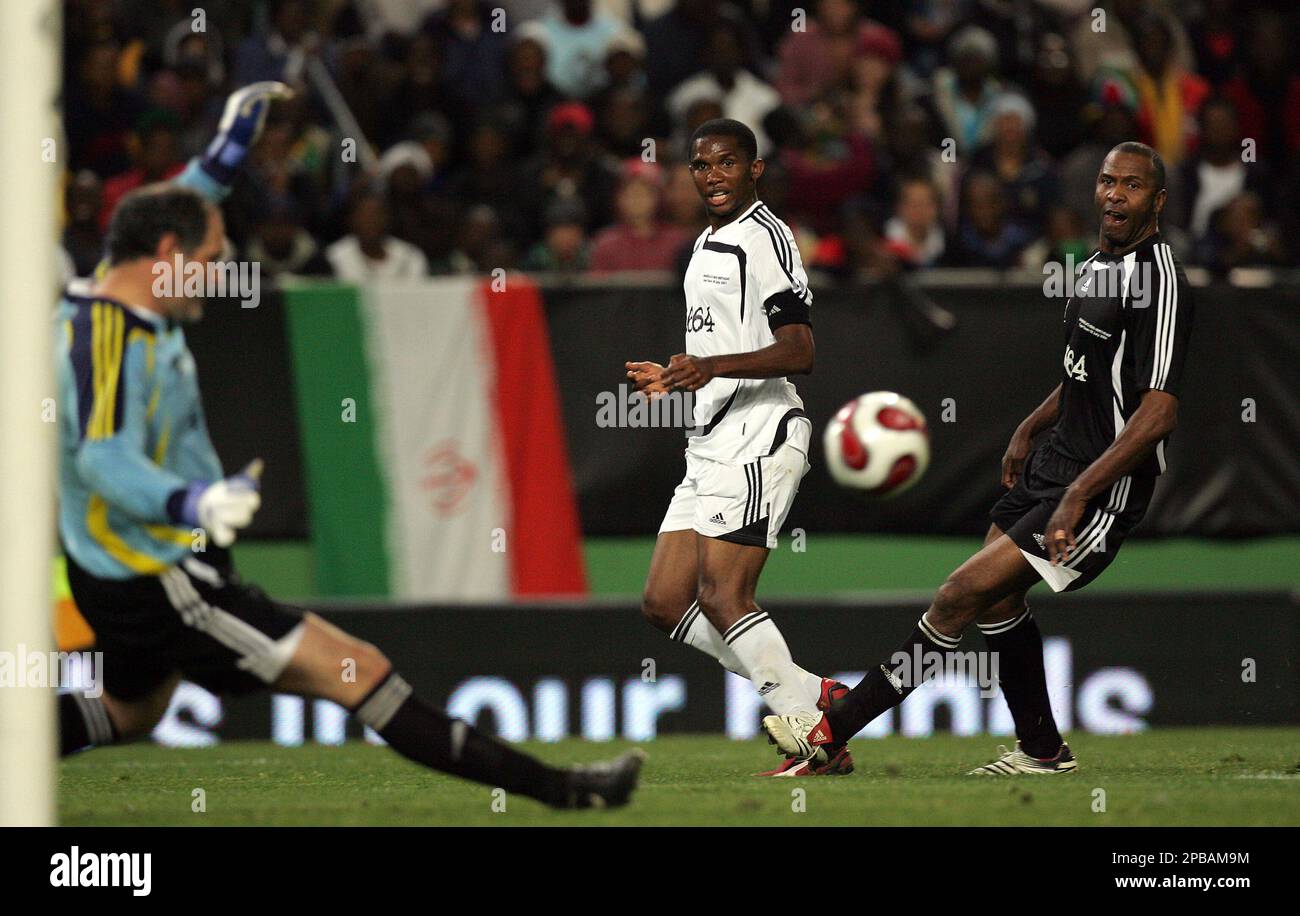 Africa XI captain Samuel Eto'o, center, looks on after taking a shot ...
