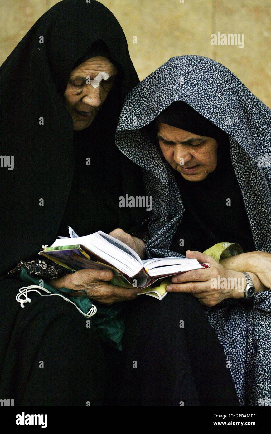 Iraqi women pray at the Imam Hussein shrine in the Shiite holy city of ...