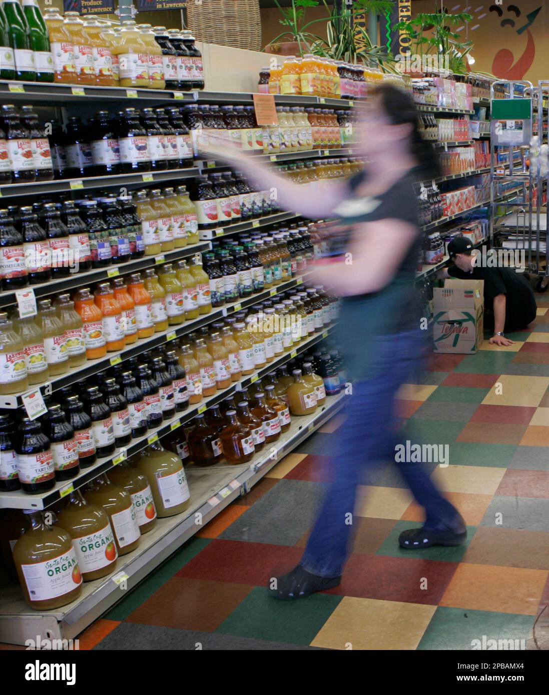 Ronda Handshy stocks shelves at The Community Mercantile, a consumer ...