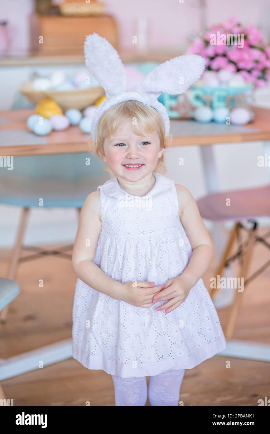 Happy Sweet cute blond girl wearing Easter bunny. Celebration of Easter ...