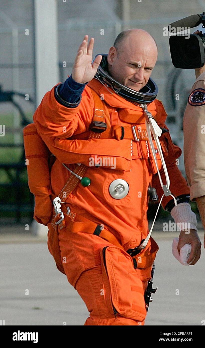 Space shuttle Endeavour commander Scott Kelly waves as he walks along ...