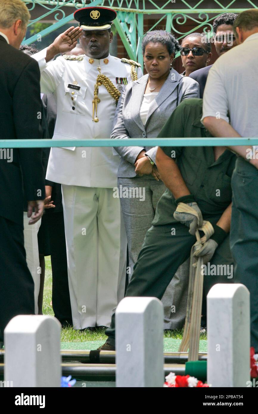 Pfc. Le Ron Wilson's father Lawrence Wilson salutes as cemetery workers ...