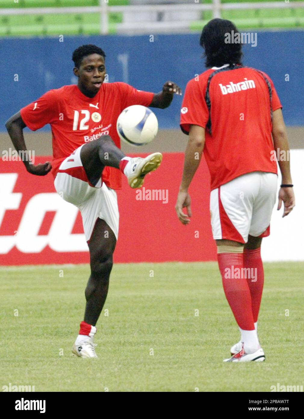 Bahrain soccer player Abdulla Fatadi, left, kicks a ball during a ...