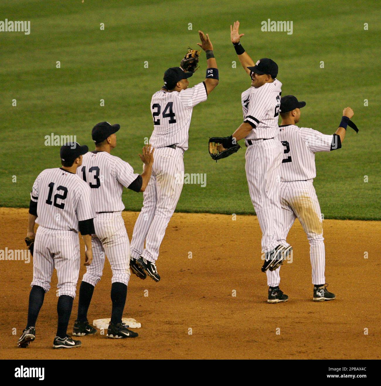 New York Yankees' Robinson Cano (24) and Melky Cabrera leap in the air ...