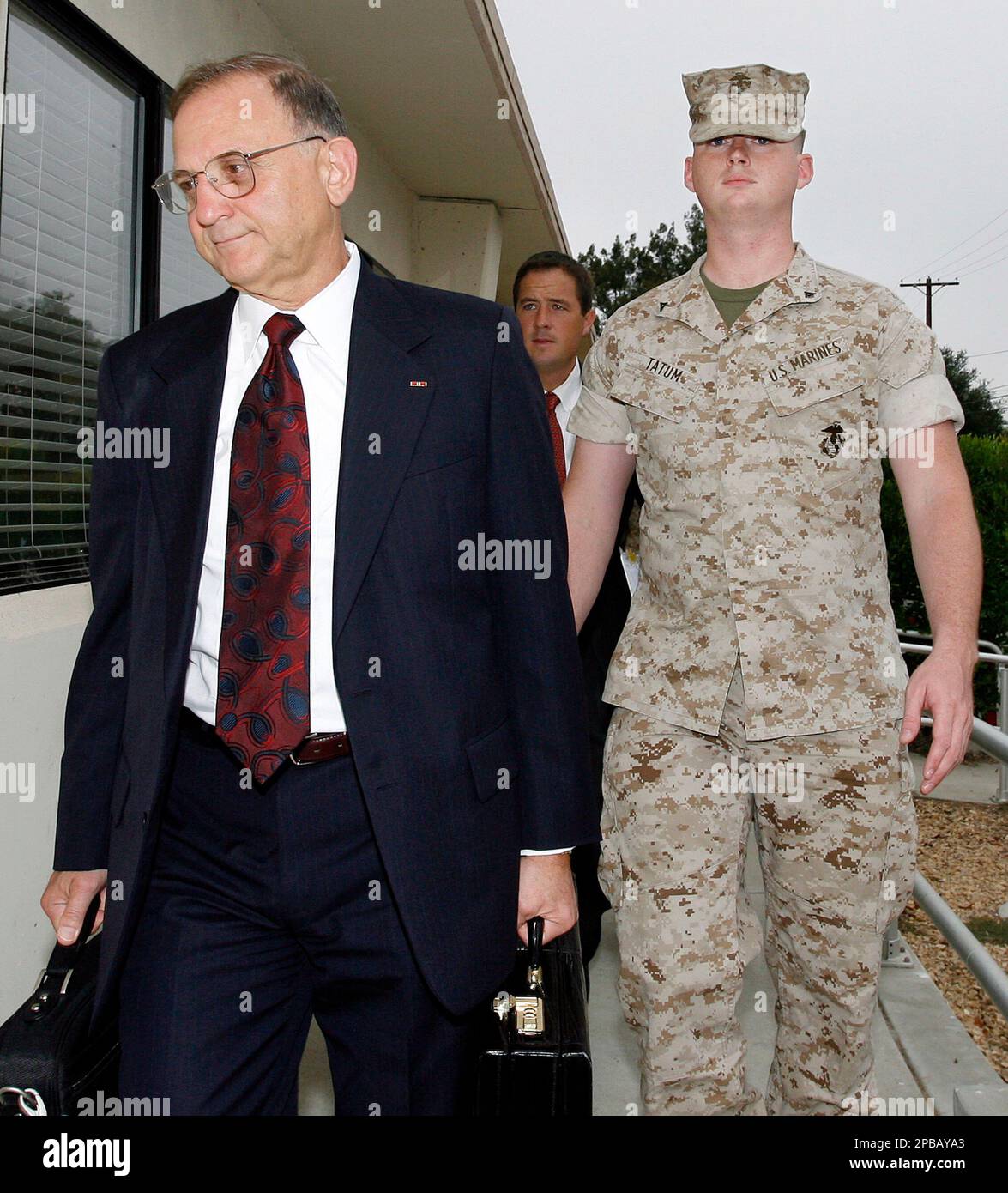 Marine Lance Cpl. Stephen B. Tatum, right, arrives with his civilian ...