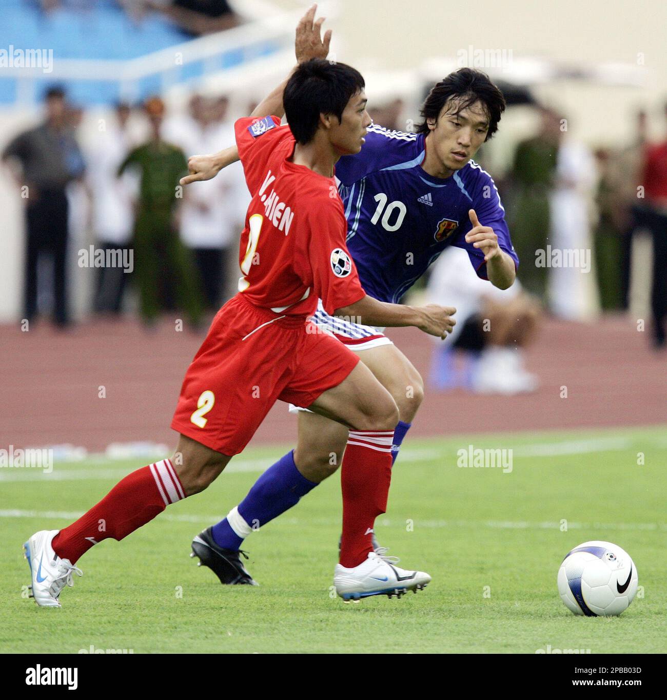 Japan's Shunsuke Nakamura, (10), fights for the ball with Vietnam's ...