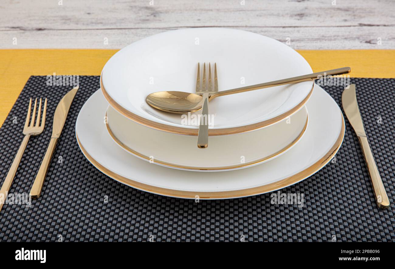 Plates and utensils, Plate, Bowl and golden cutlery on dining table ...
