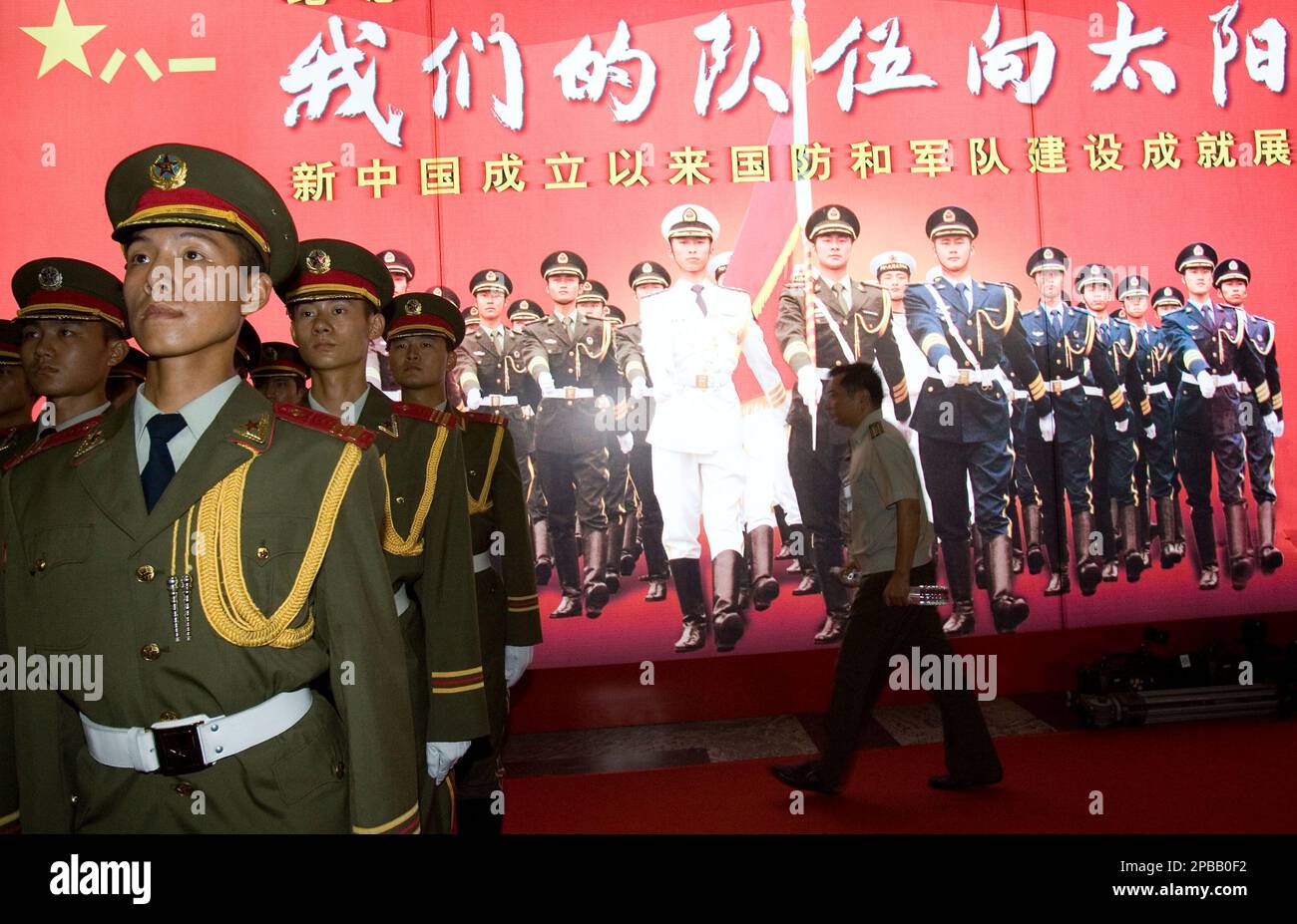 Chinese soldiers attend the opening of an exhibition to mark China's ...