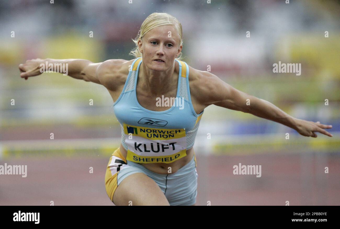 Carolina Kluft of Sweden crosses the line in the women's 100 metres ...