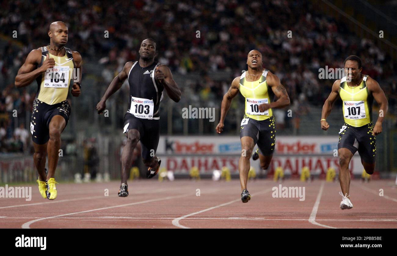 Jamaica's Asafa Powell, left, crosses the finish line to win the men's ...