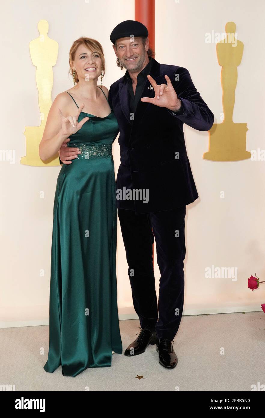 Deanne Bray, left, and Troy Kotsur signs 'I love you' as they arrive at ...