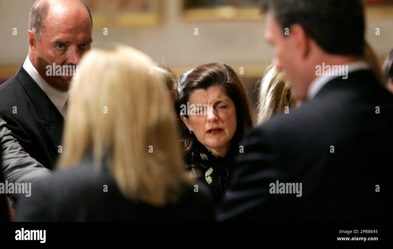 Luci Baines Johnson, center, prays with her husband, Ian Turpin, left ...