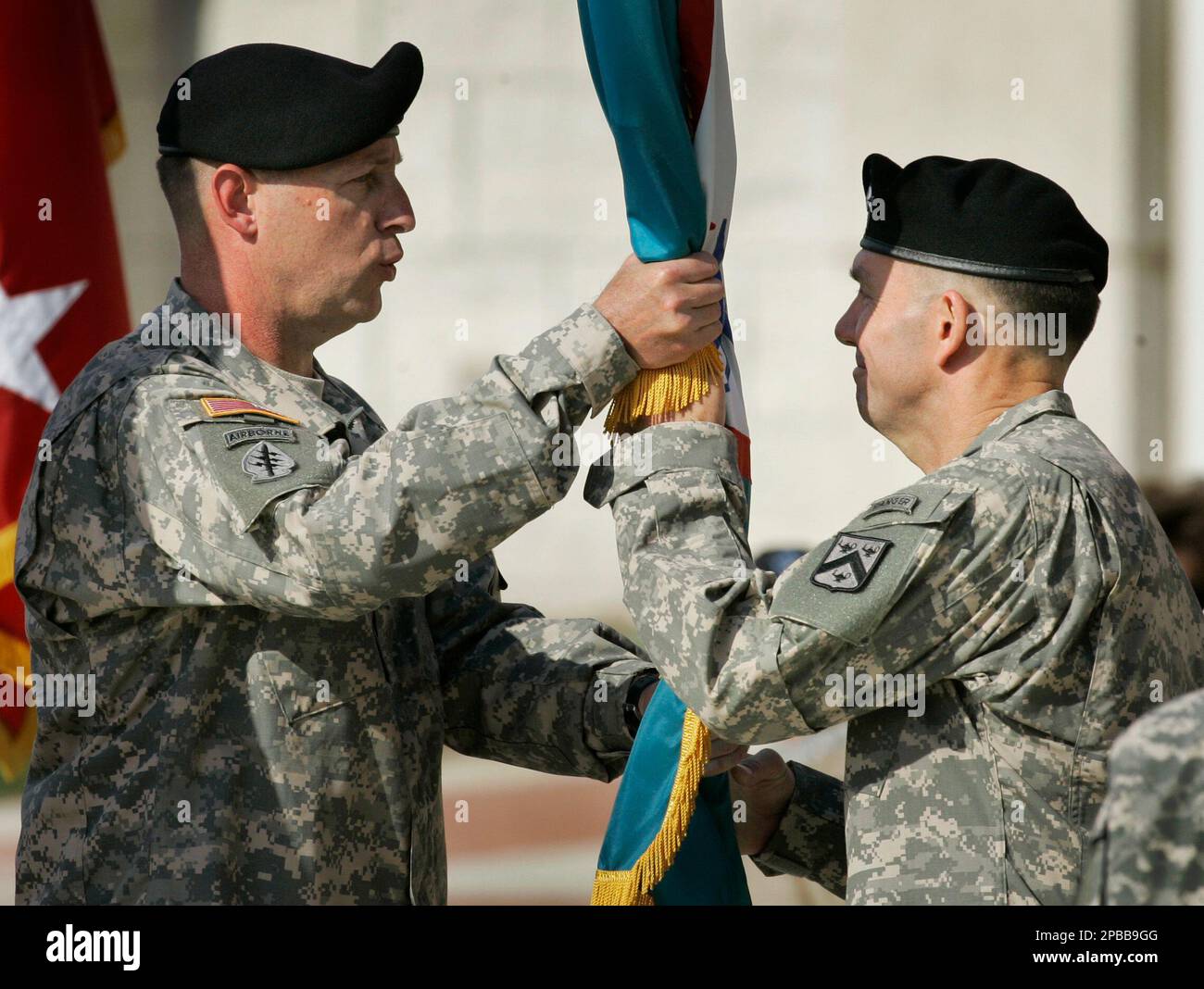 Lieutenant General William Caldwell, right, passes his colors to ...