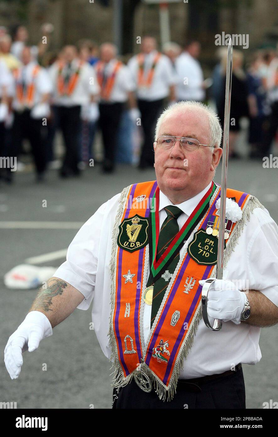 An Orange Order member parades through a loyalist part of east Belfast ...