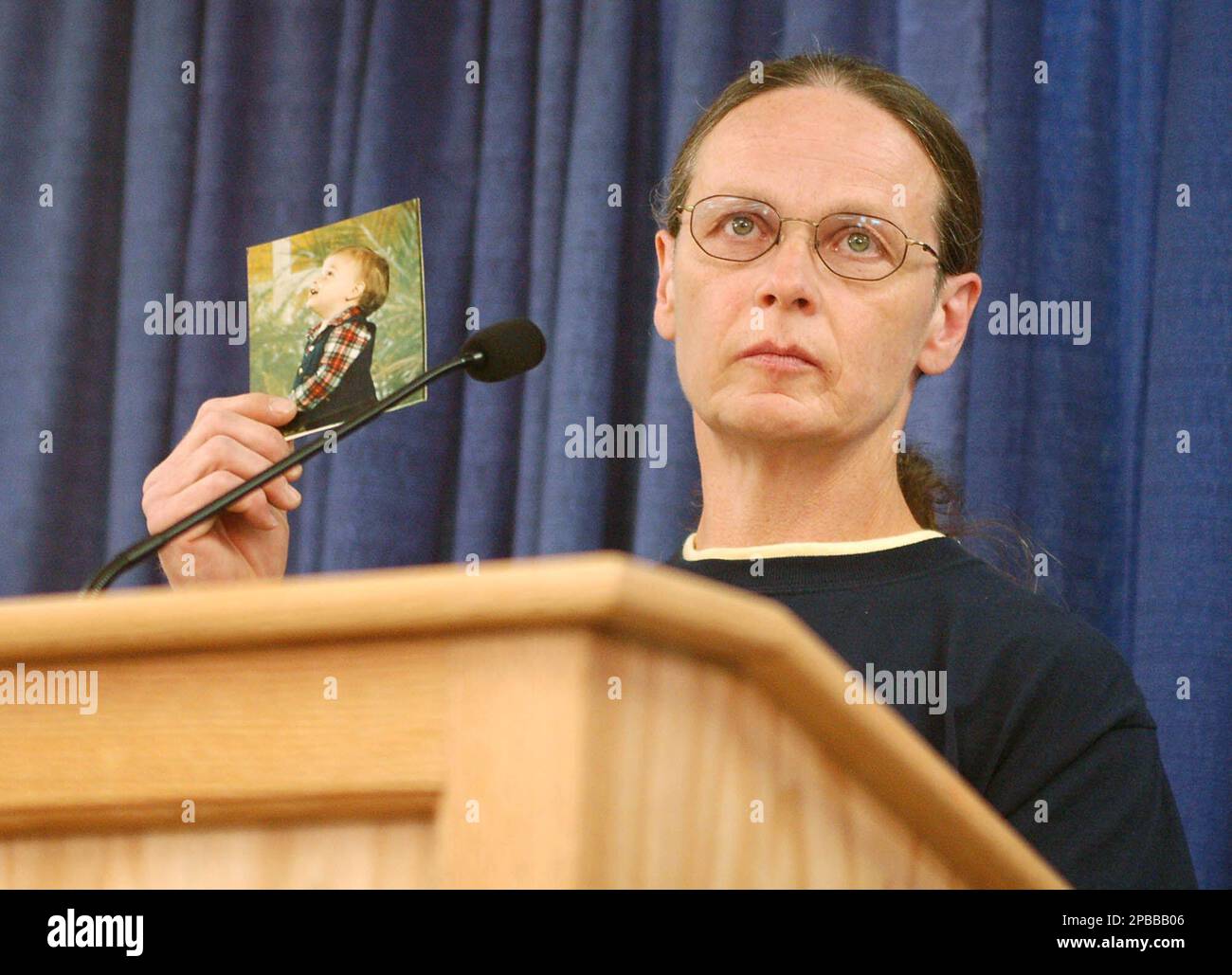 Dottie Poage holds a chilhood picture of her son Chester Allan Poage ...