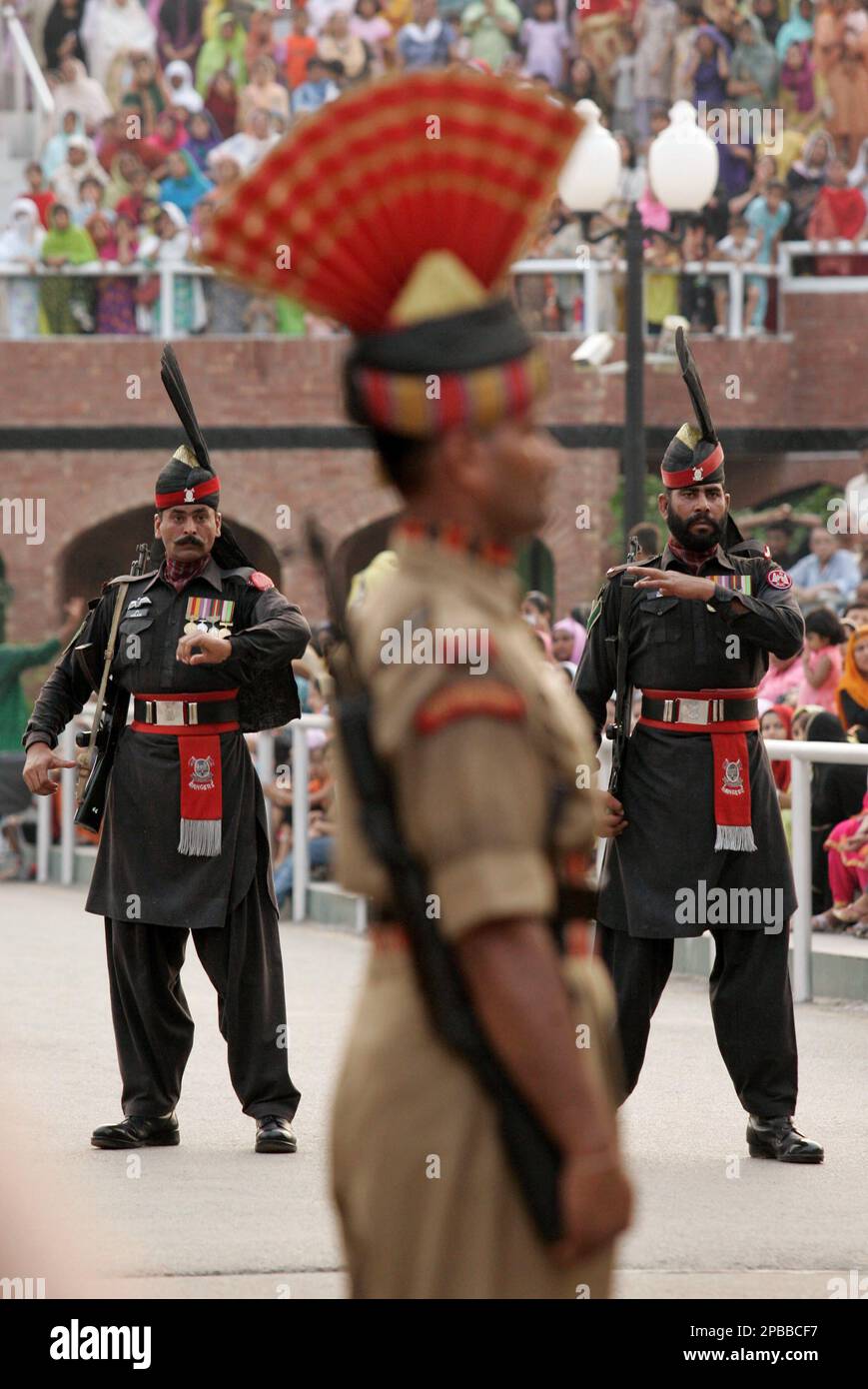 An Indian Border Security Force soldier, foreground, and Pakistan ...