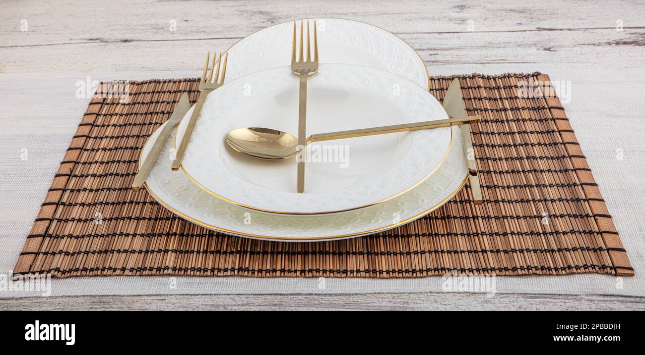 Plates and utensils, Plate, Bowl and golden cutlery on wicker american ...