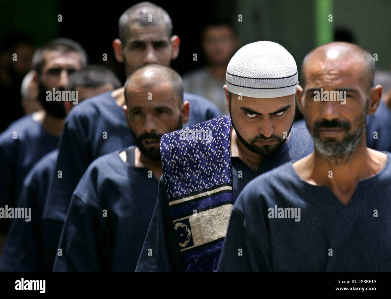 Palestinian prisoners line up in the exercise yard at the Hamas ...