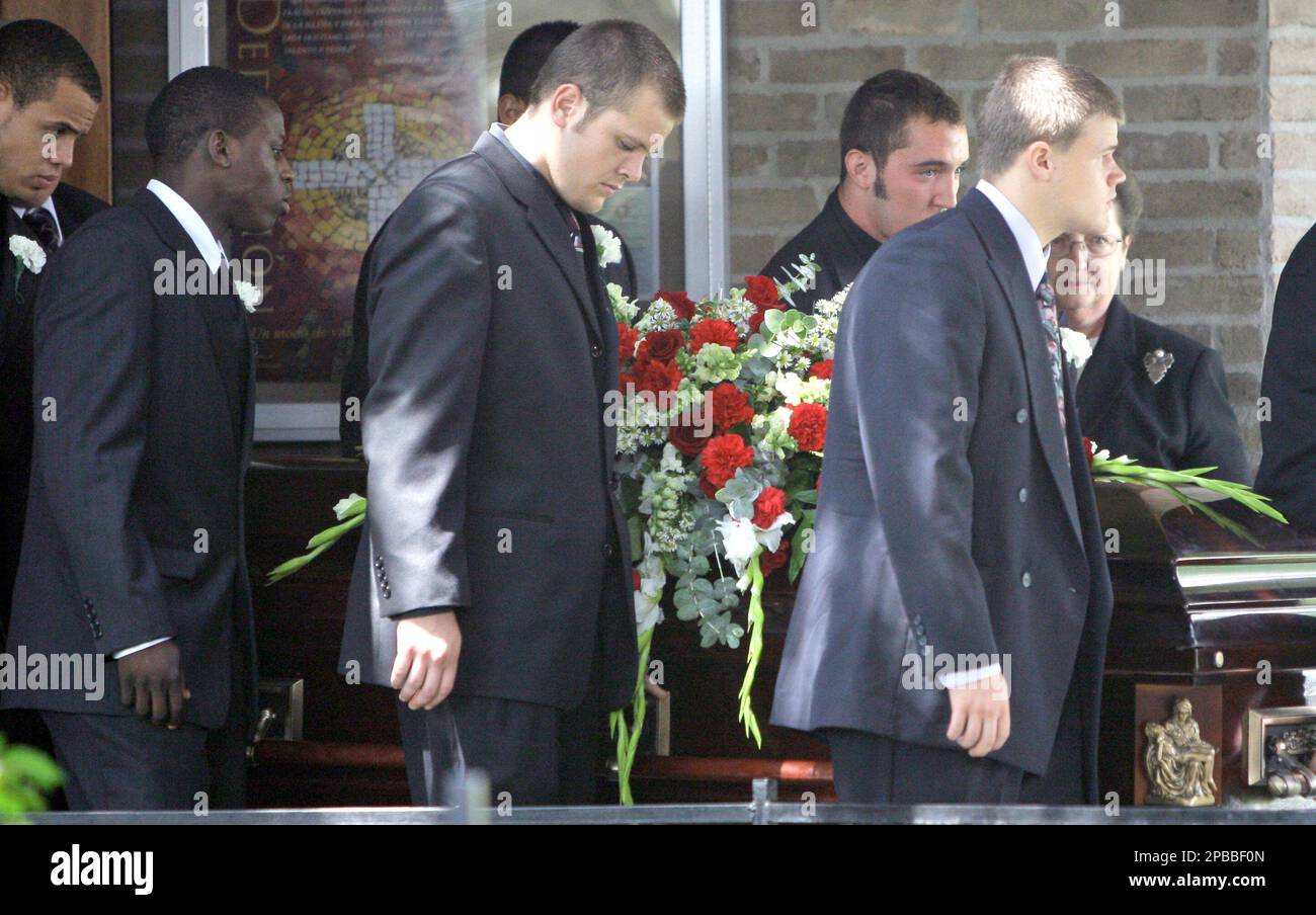 The casket of David Ritcheson is wheeled from the church after his ...