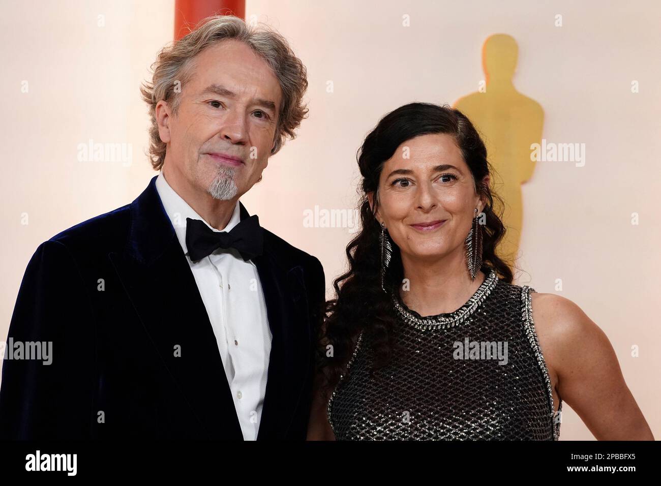 Carter Burwell, left, and Christine Sciulli arrives at the Oscars on ...