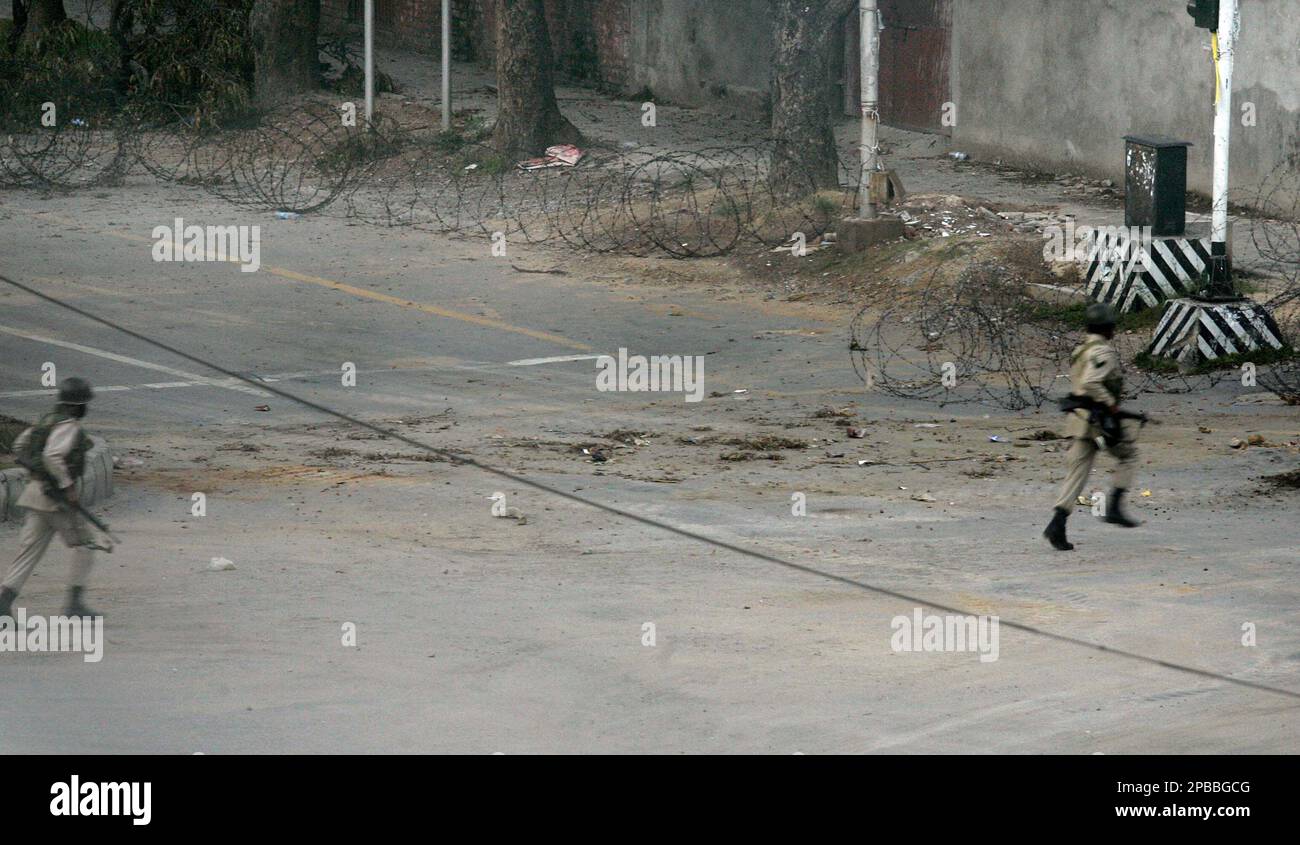 Pakistani paramilitary troops run to take position during a heavy ...