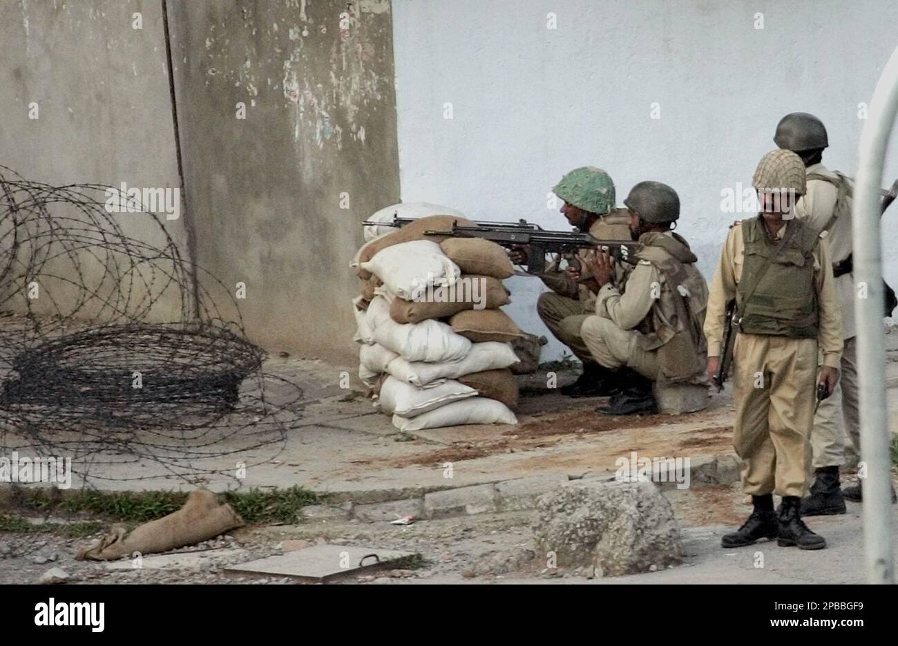 Pakistani paramilitary troops take position during heavy gunbattle with ...