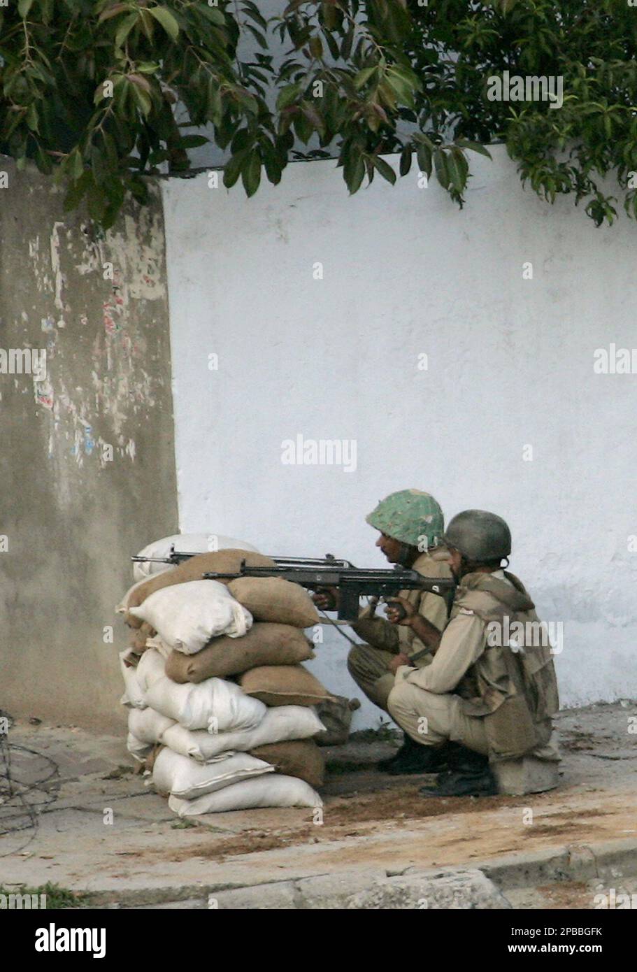Pakistani paramilitary troops take position during heavy gunbattle with ...