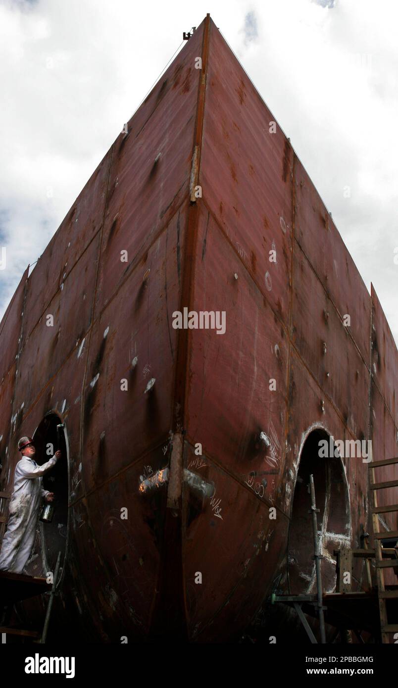 Mark St. Amand, of Windsor, Maine, tests the welds on the bow section ...