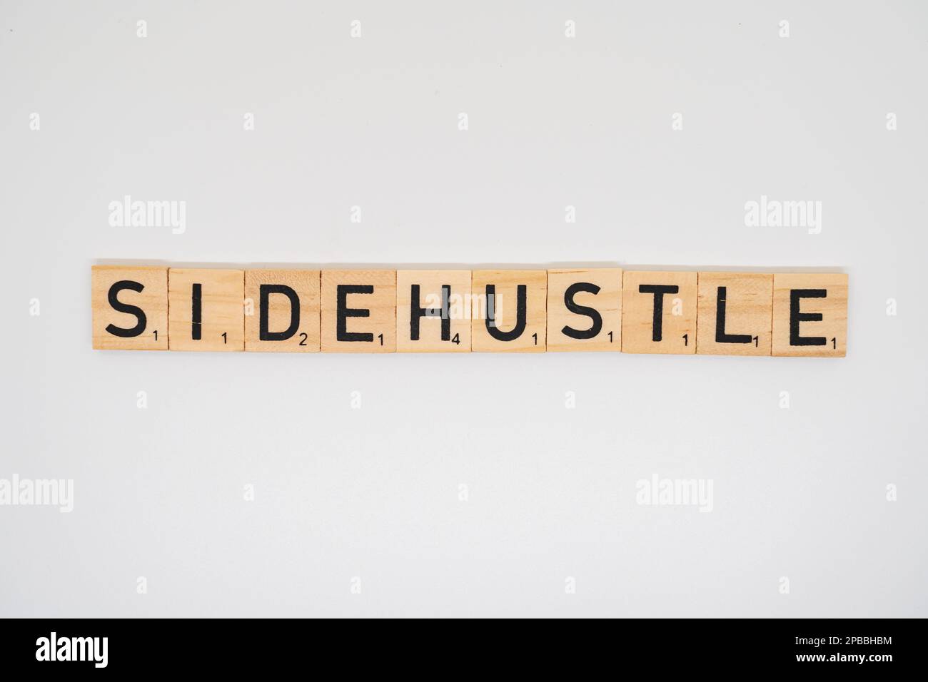 Wooden title spelling the words side hustle isolated on a white ...