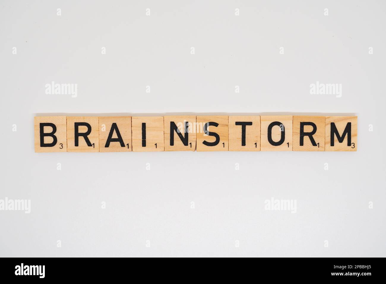 Wooden title spelling the word brainstorm isolated on a white ...