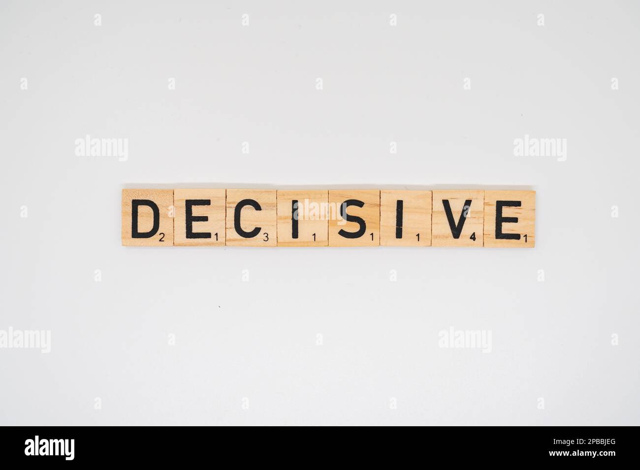 Wooden title spelling the word decisive isolated on a white background ...