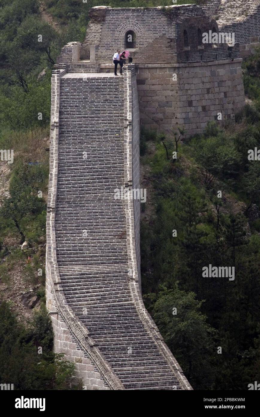 A couple enjoys a moment of quiet along a section of the Great Wall of ...