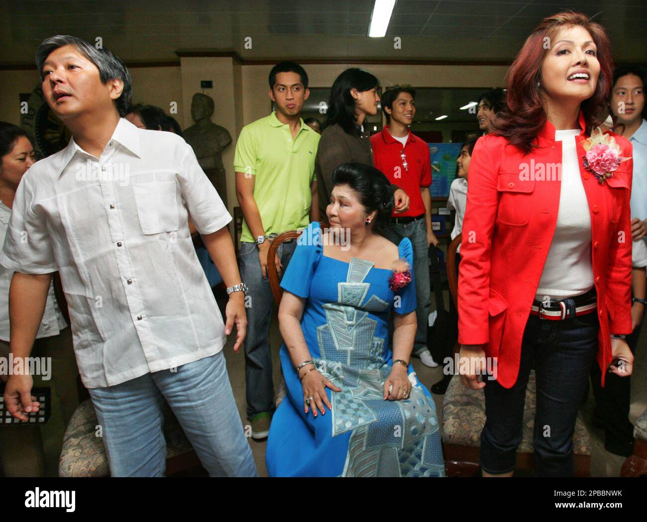 Former Philippine first lady Imelda Marcos center, waits in her chair ...
