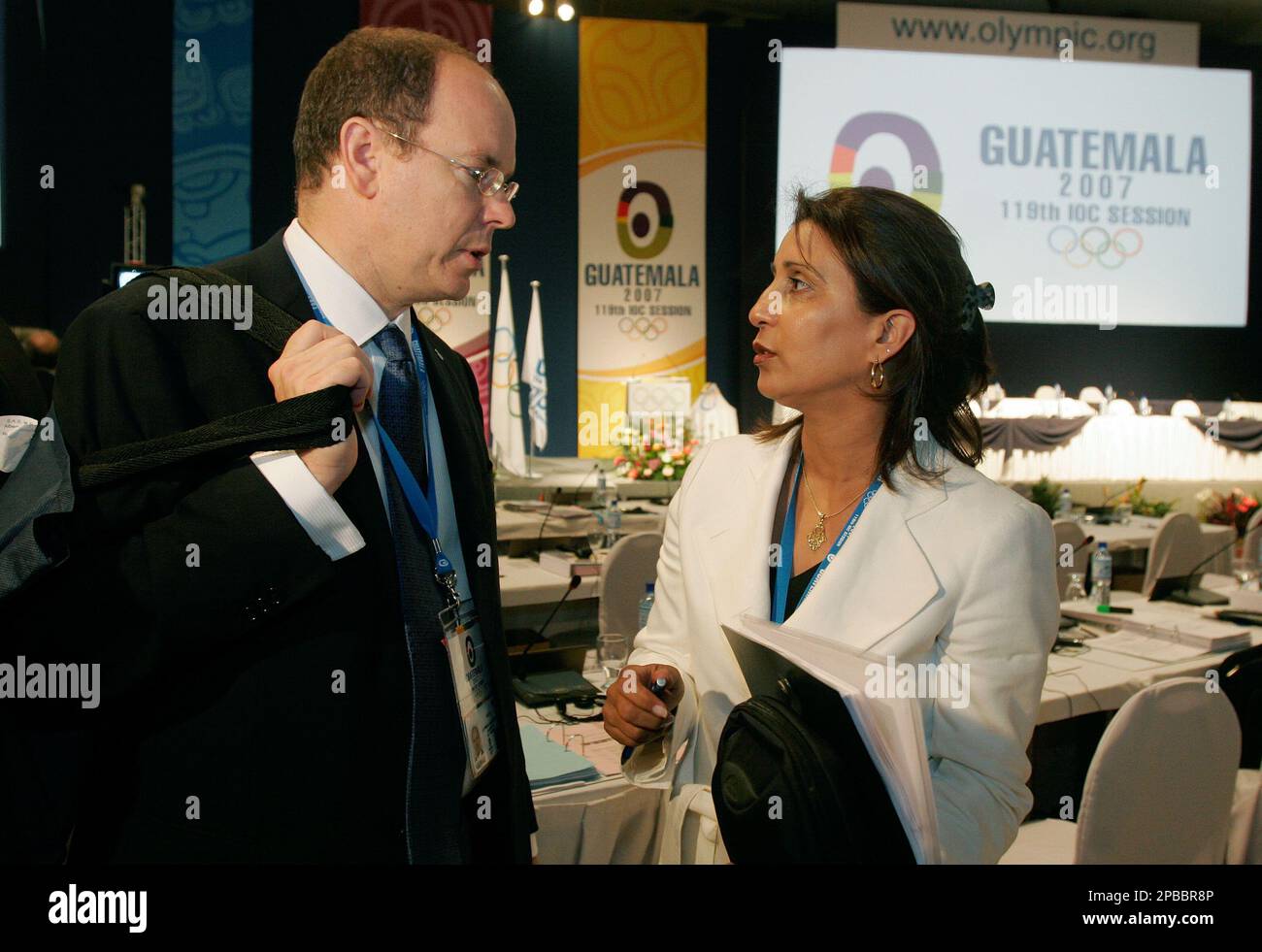 IOC member Prince Albert II of Monaco speaks with fellow member Rania ...