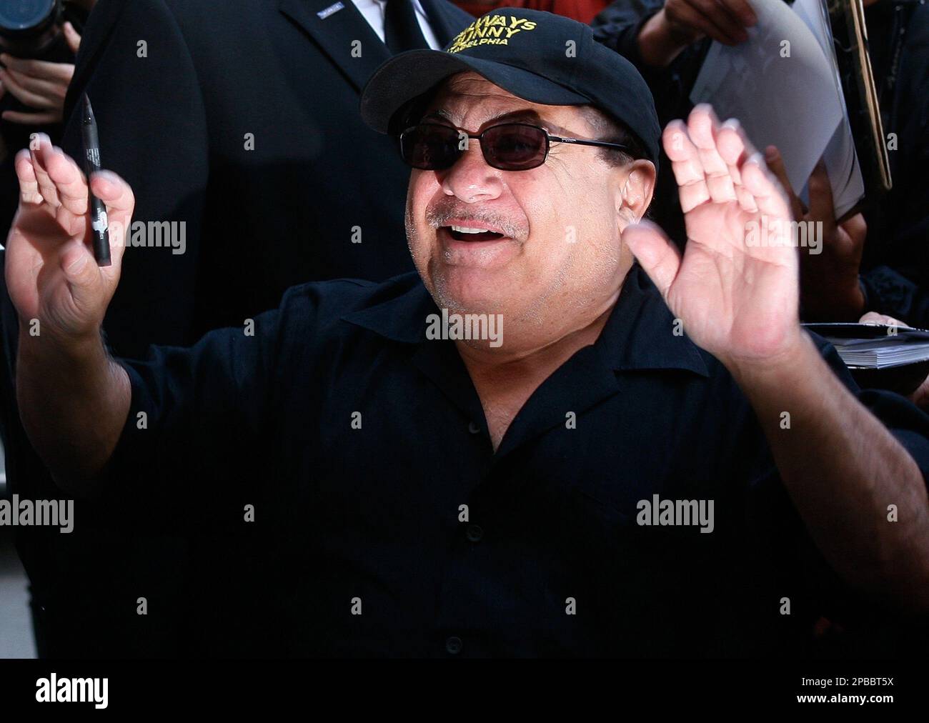 U.S. actor Danny DeVito jokes with photographers as he arrives for the ...