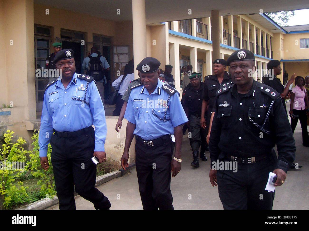 Rivers State Police Commissioner Felix Ogbaudu, left, walks with ...