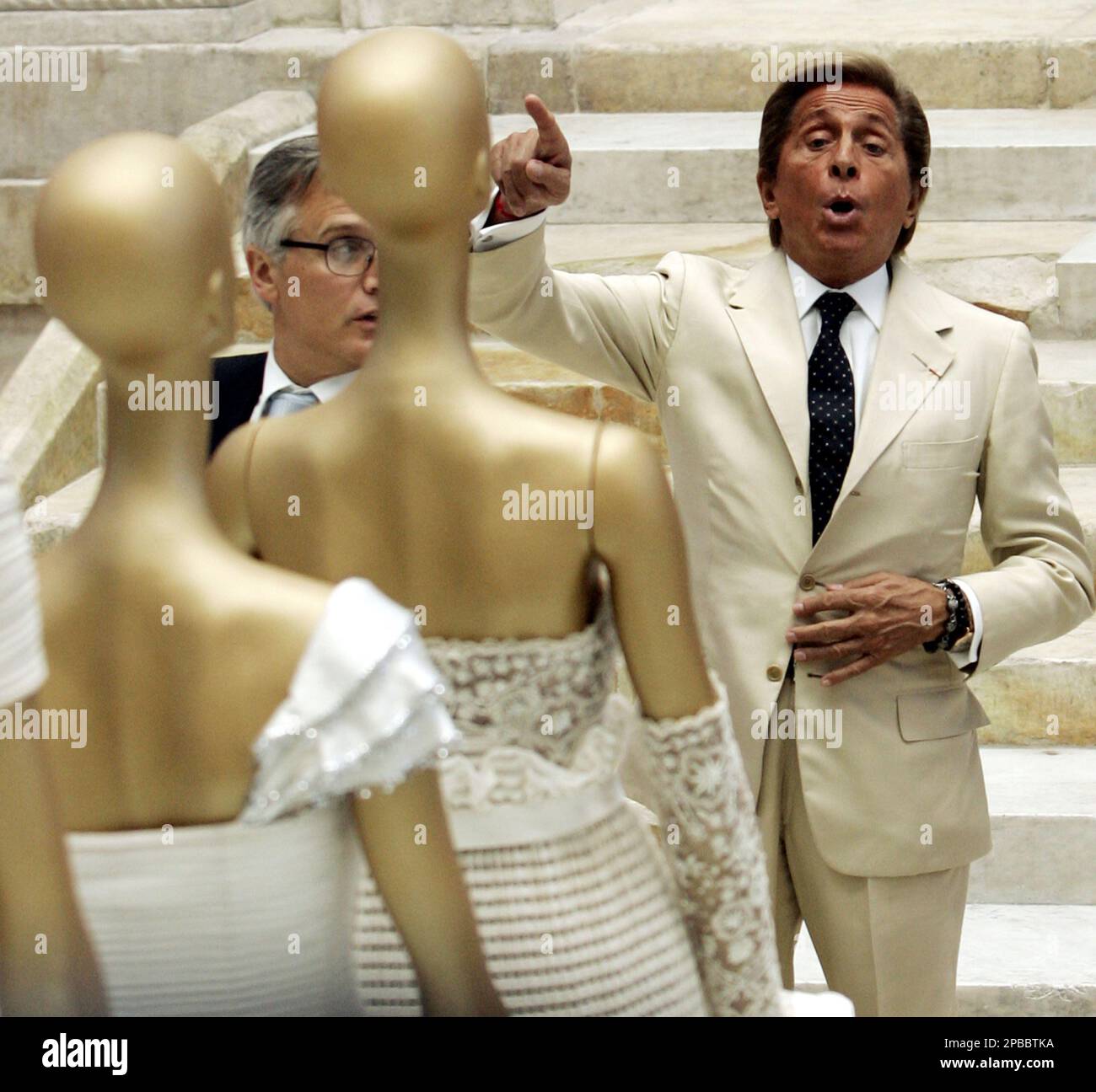Italian fashion designer Valentino, right, gestures during the ...