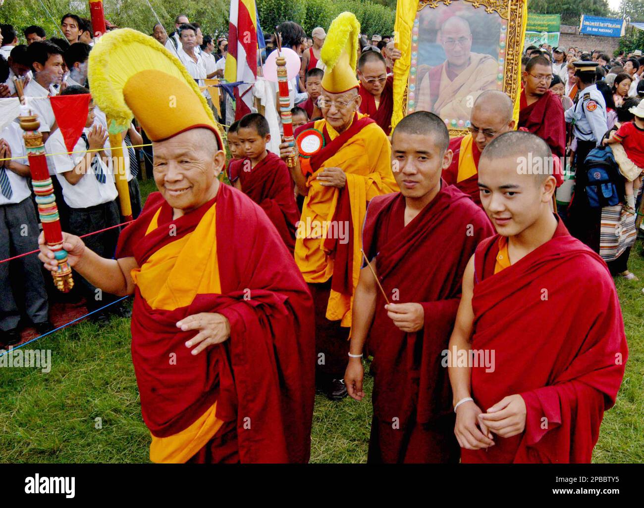 Tibetan monks carry a portrait of their spiritual leader The Dalai Lama ...