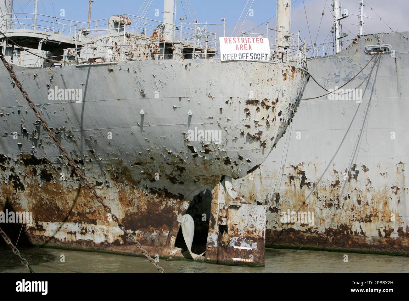 A pair of aging and rusting World War II Victory ships are anchored ...