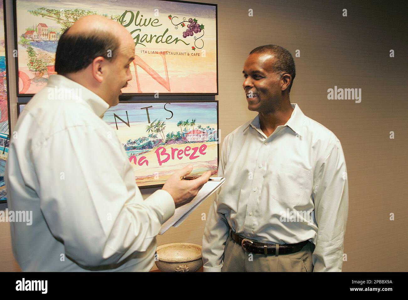 Darden Restaurant's Chief Executive Officer, Clarence Otis, right ...