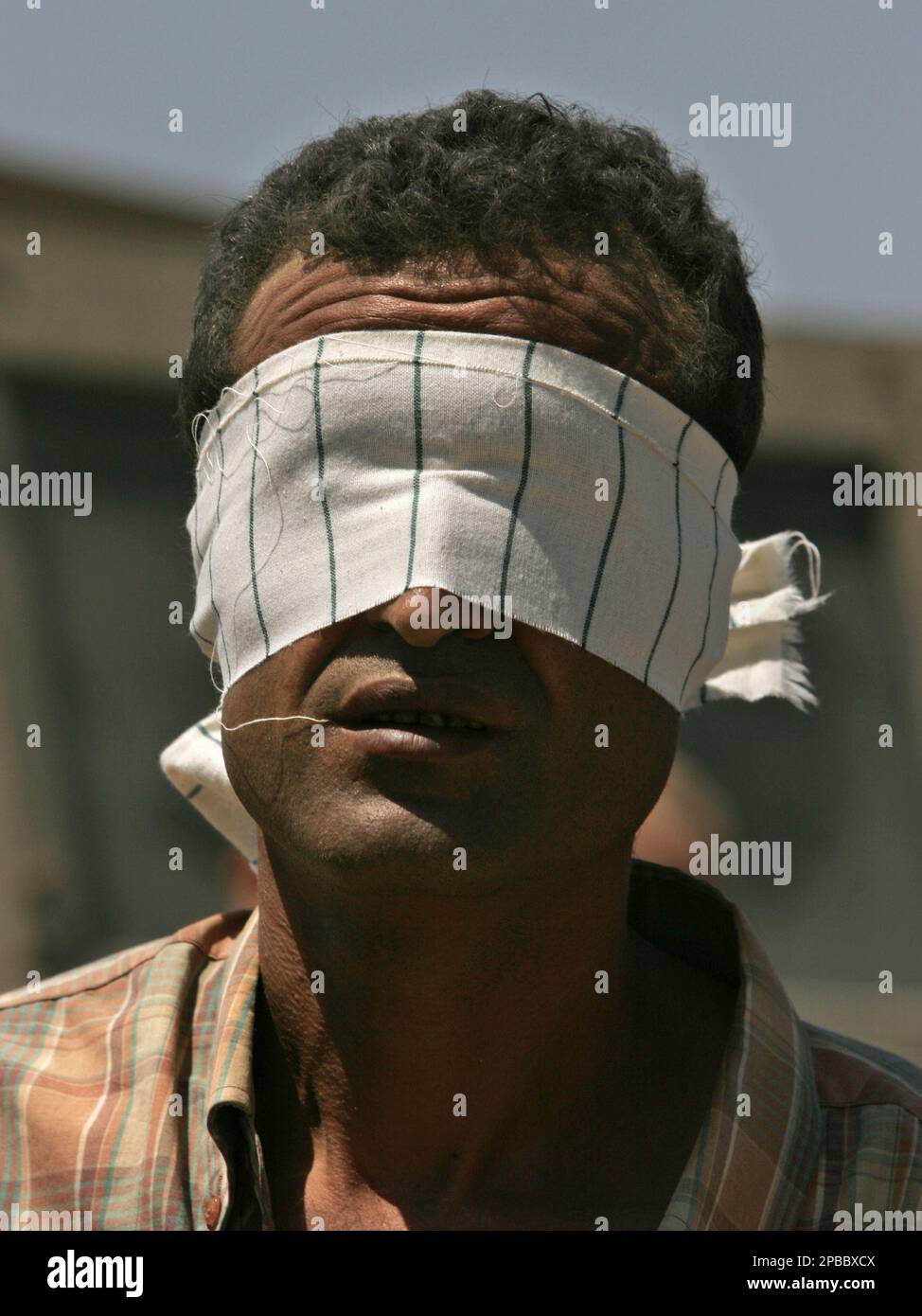 A blindfolded Palestinian is seen following his arrest by Israeli ...