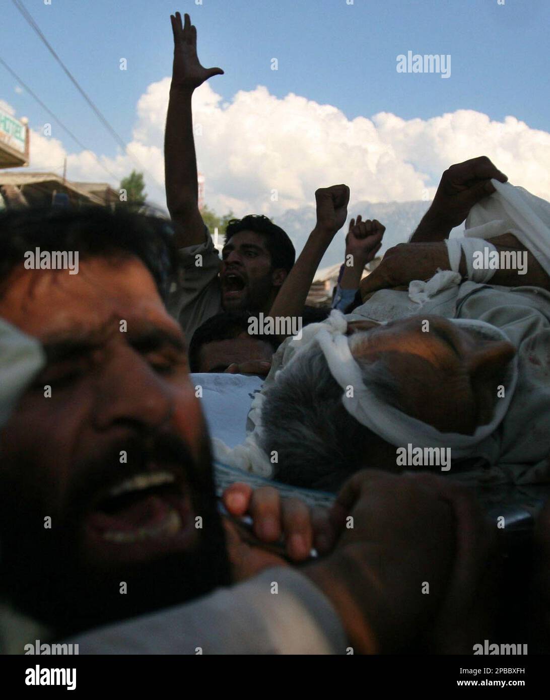 Kashmiri Muslim protesters shouts slogans as they carry the dead body ...