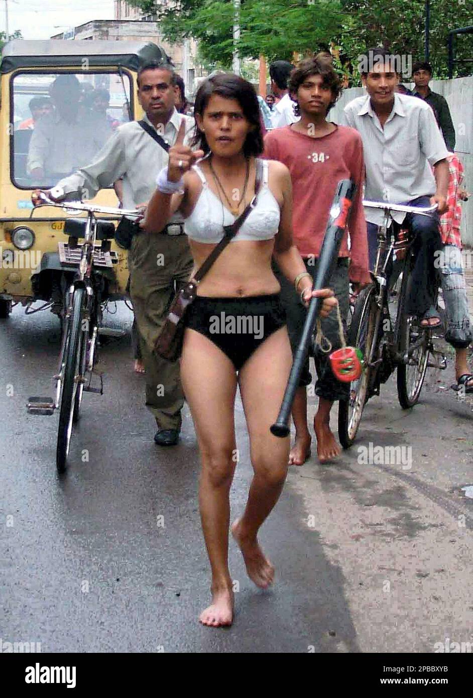 An Indian woman, Pooja Chauhan, in her undergarments and carrying a baseball bat and bangles in ...