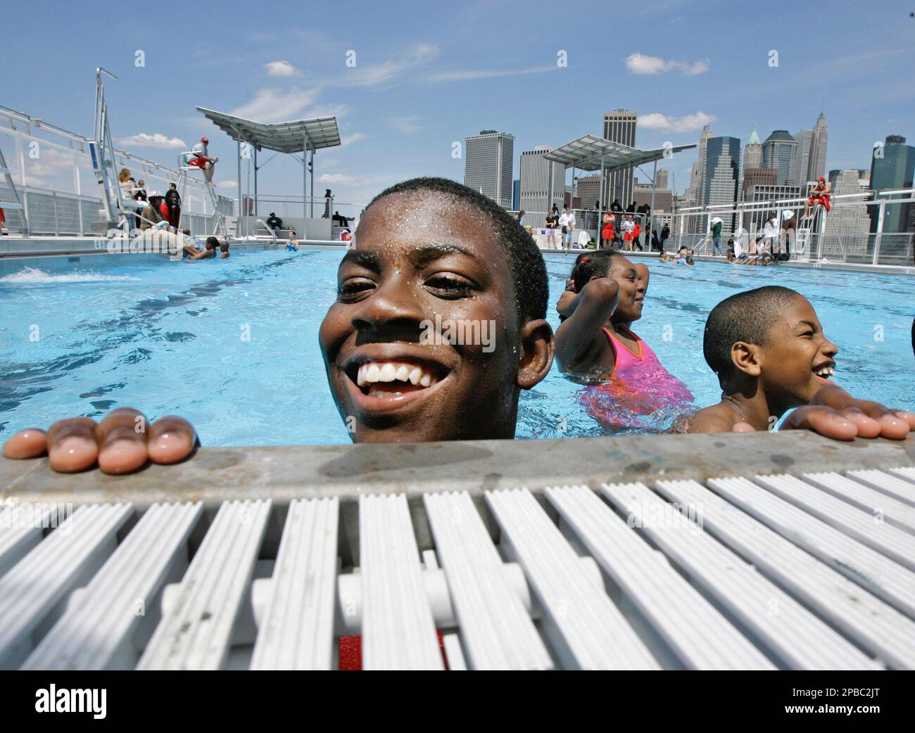 New York City's skyline is visible as Joshua McGregor, 11, Nayhira ...