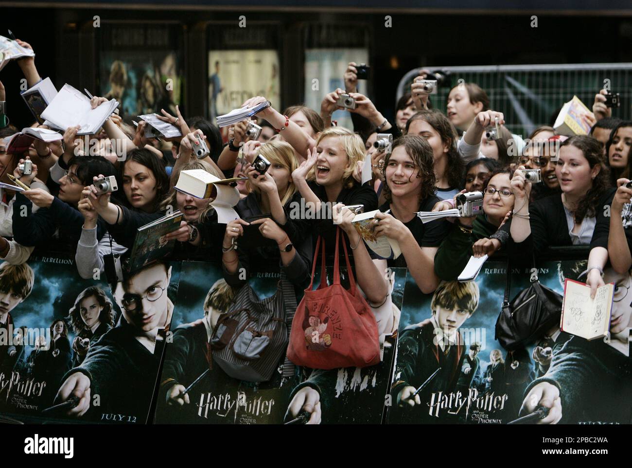 Fans crowd around the barrier trying to attract actor Daniel Radcliffe ...