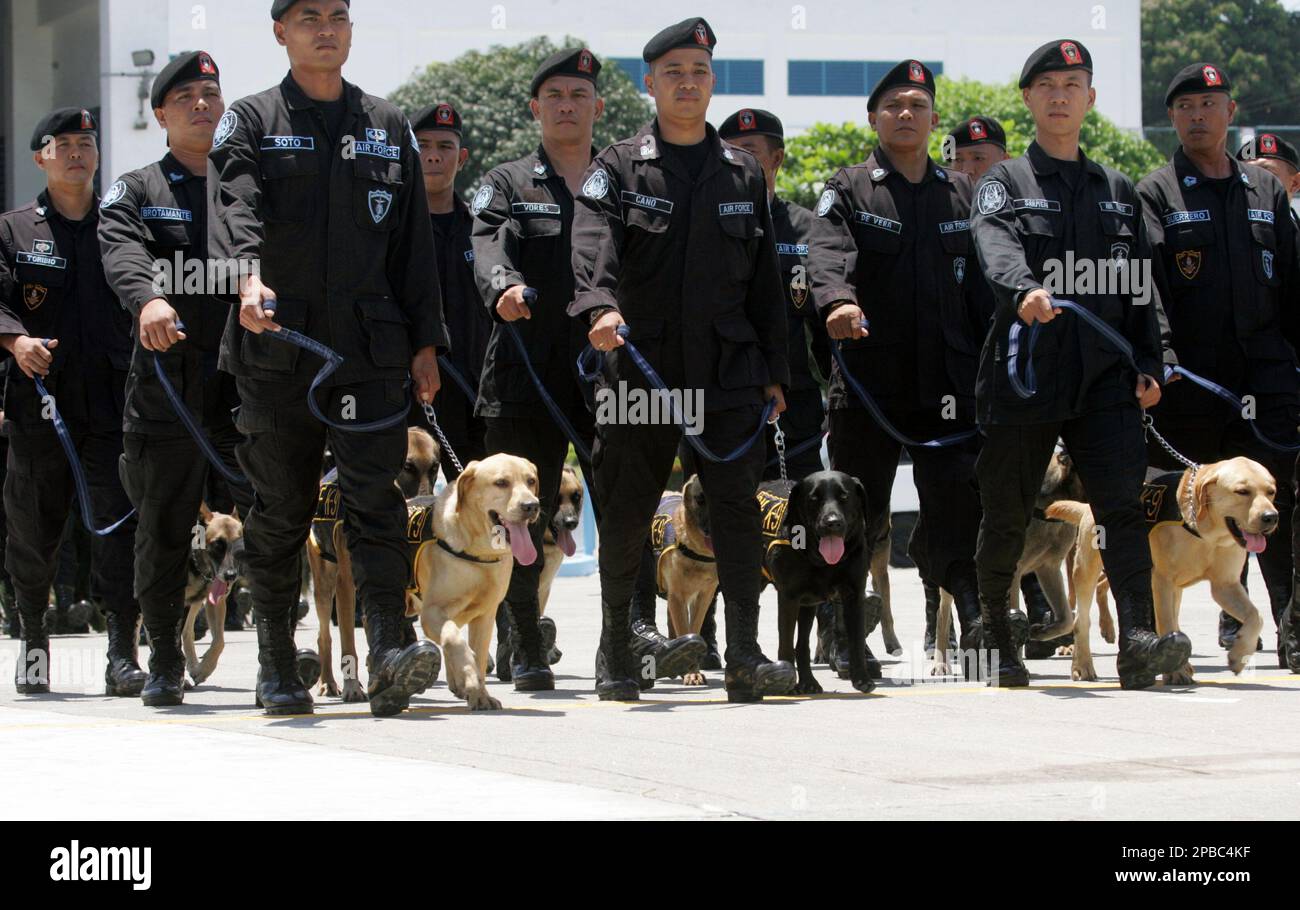 A platoon of K-9 dogs of the Philippine Air Force join their handlers in marching during ...