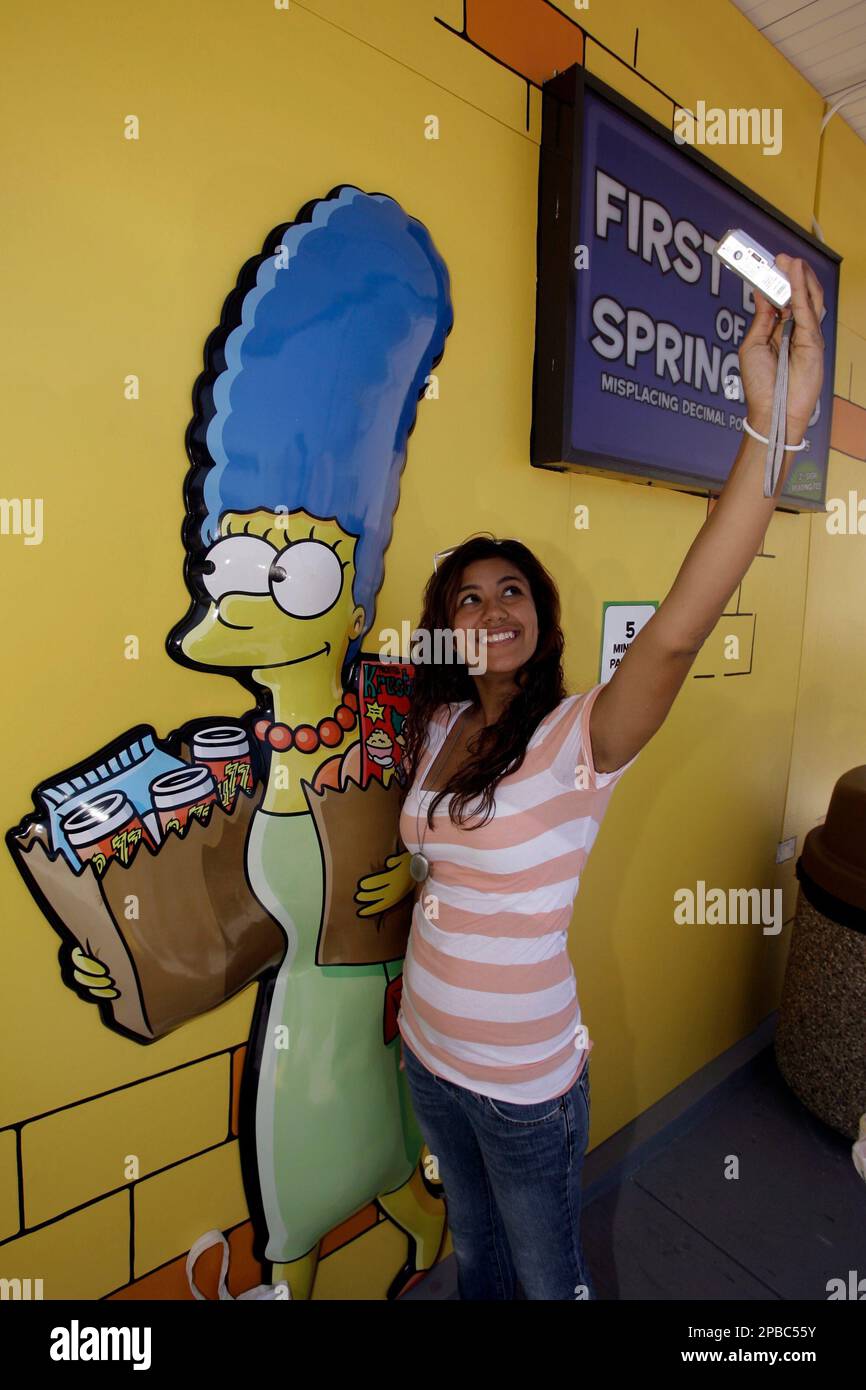 Student Emily Fajardo, 16, takes her picture outside the 7-11 "Kwik-E ...